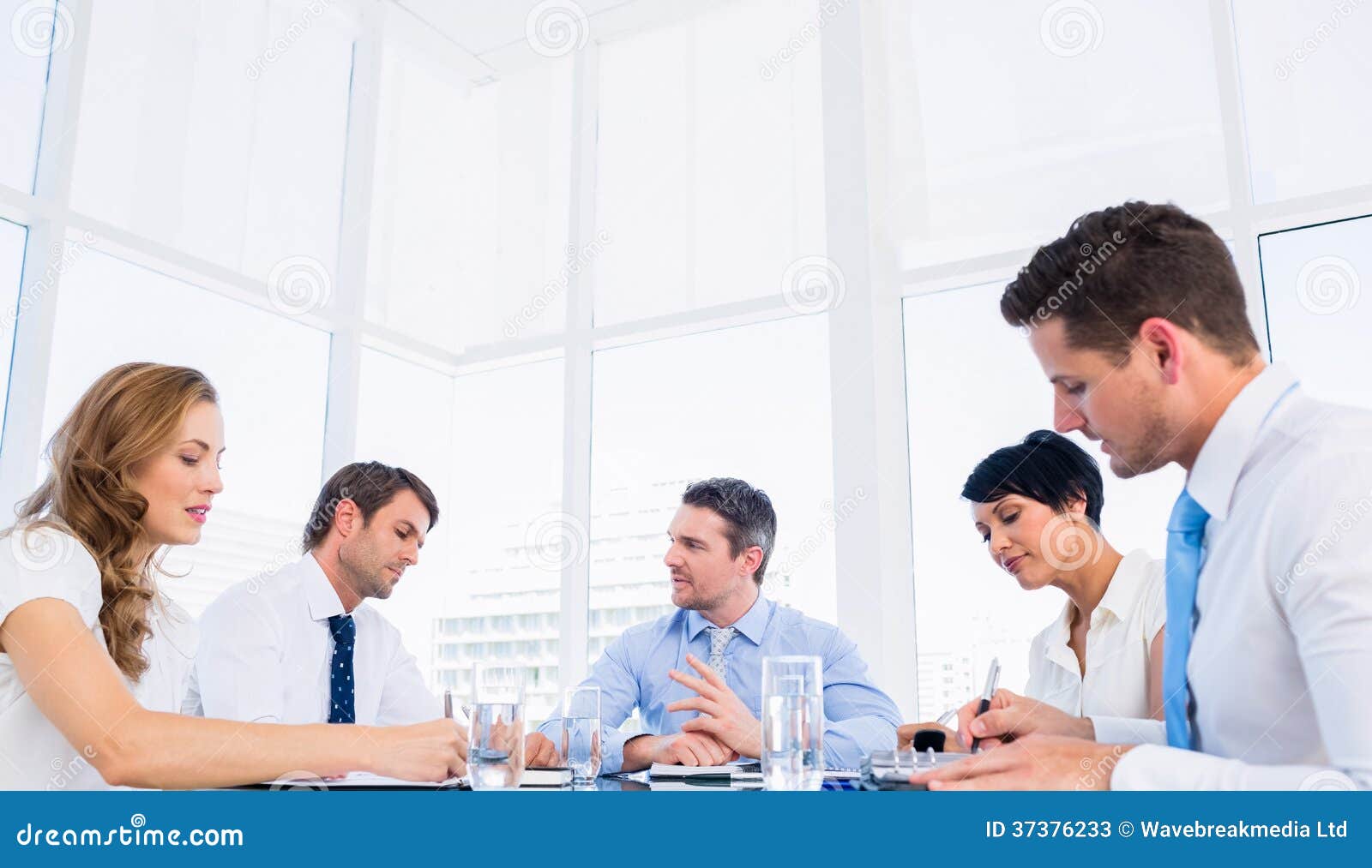 Executives Sitting Around Conference Table Stock Image - Image of male ...