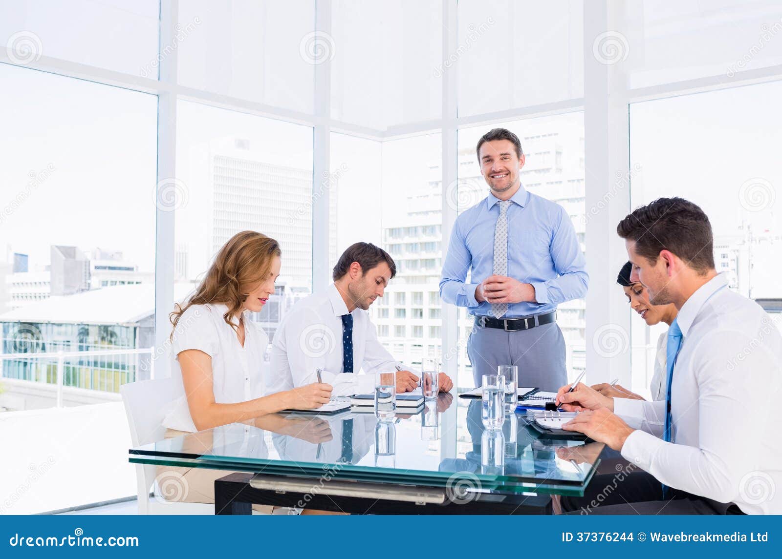 Executives Sitting Around Conference Table Stock Photo - Image of ...