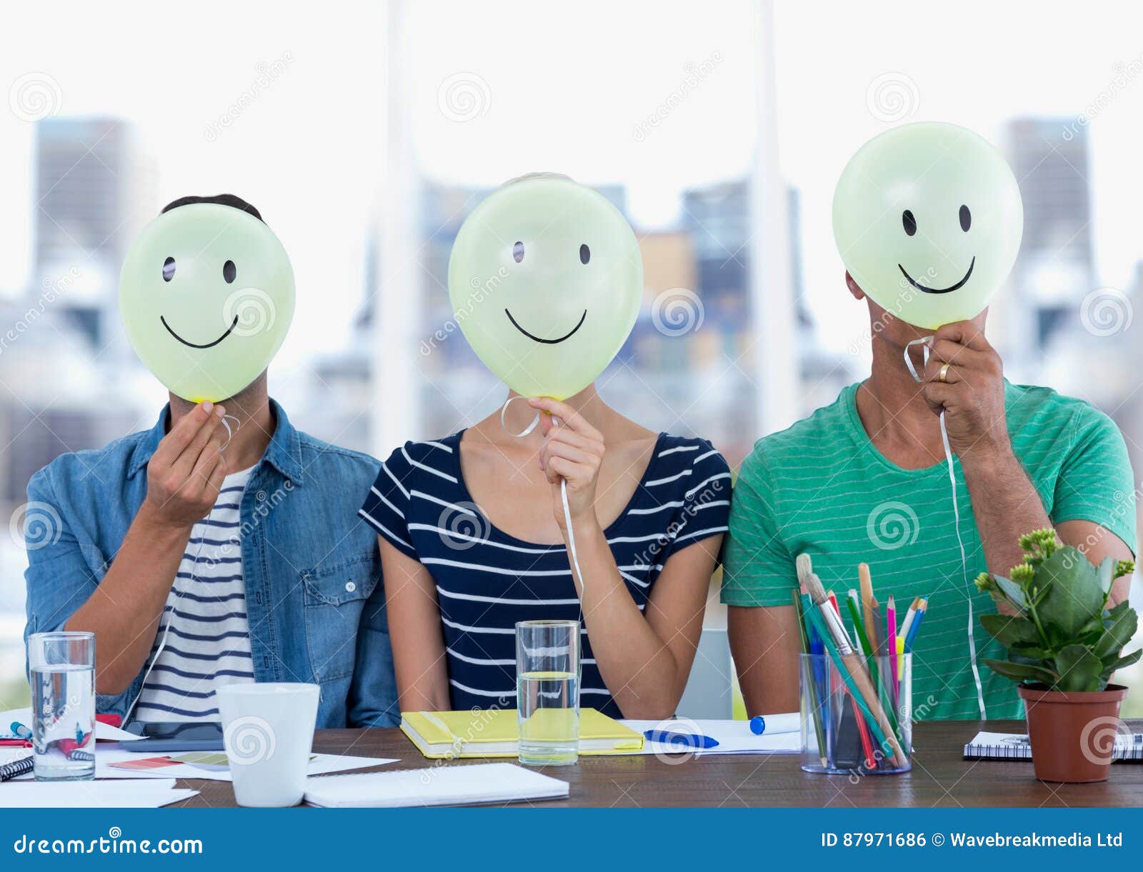 Executives Sitting at Desk with Smiley Faces on Their Face Stock Photo ...