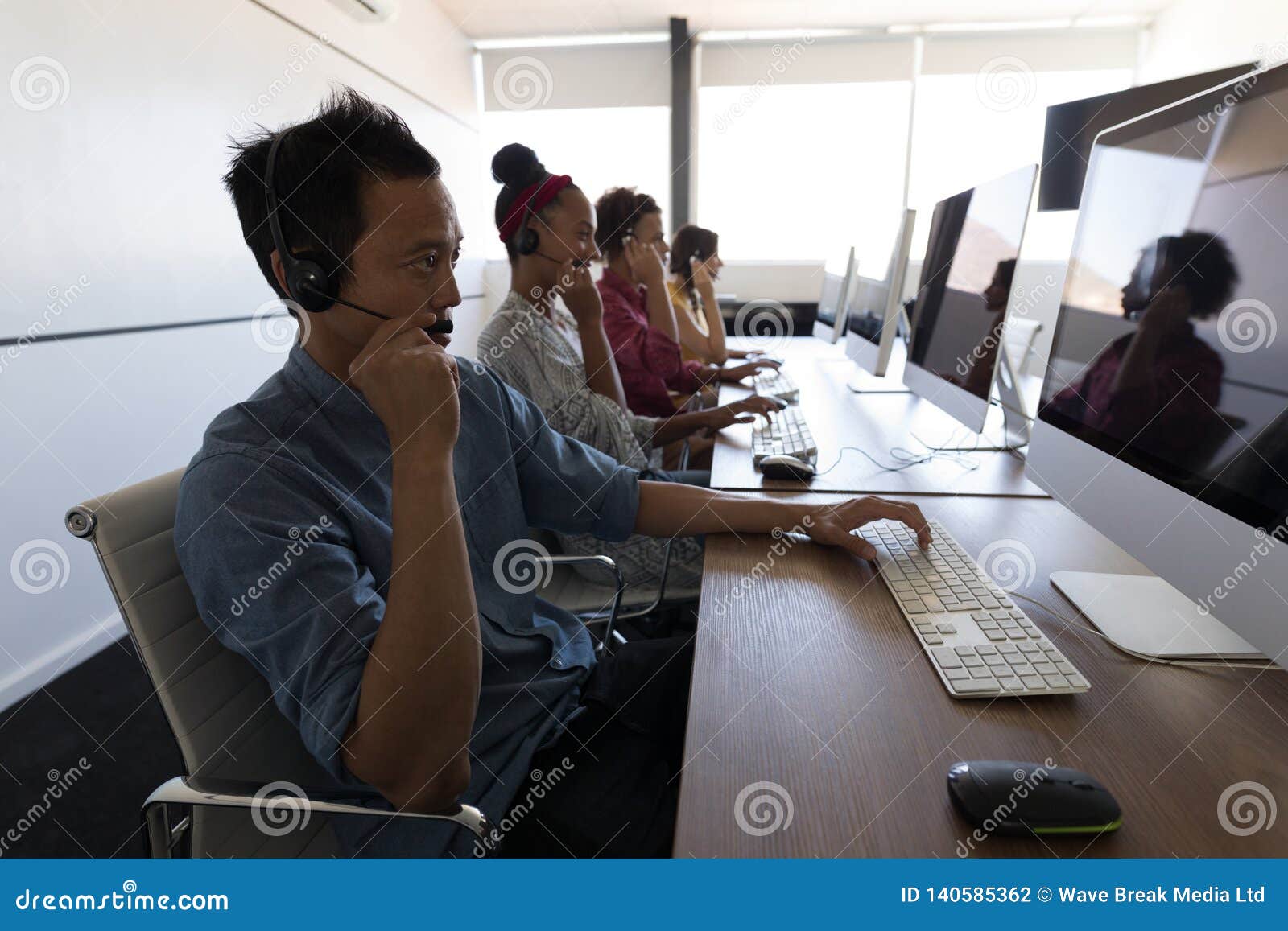 Executives Talking on Headset in Office Stock Photo - Image of ...