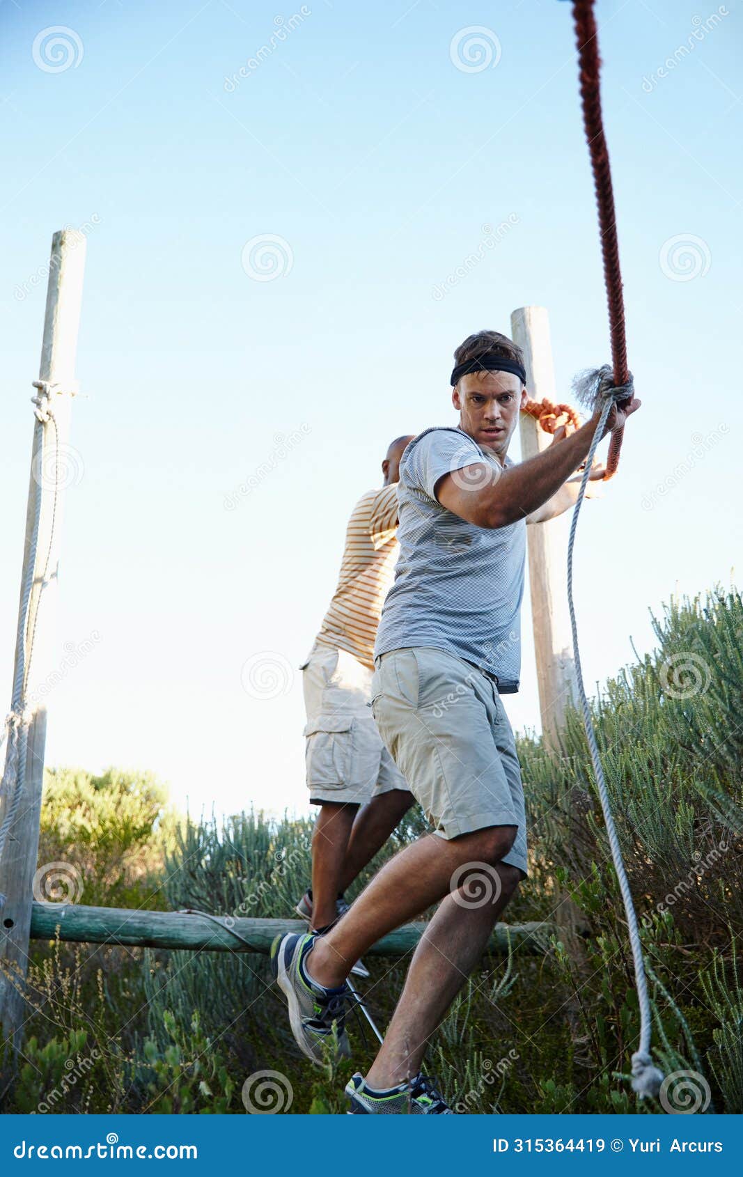 Exercise and Adventure. Shot of Men Going through an Obstacle Course at ...