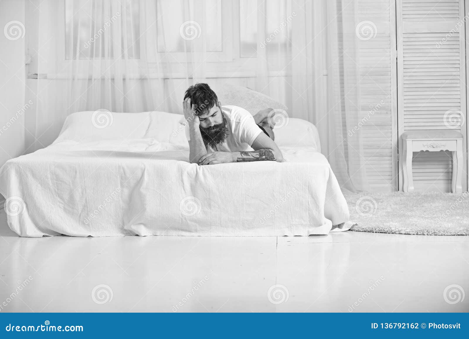 Exhausted Concept. Man Laying on Bed, Falling Asleep while Lean on Hand ...