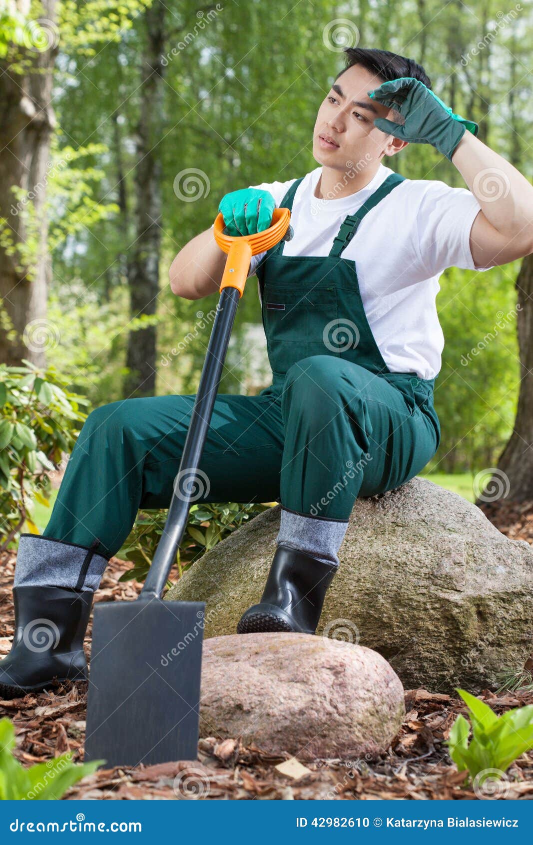 Exhausted Gardener Resting on a Rock Stock Photo - Image of green ...