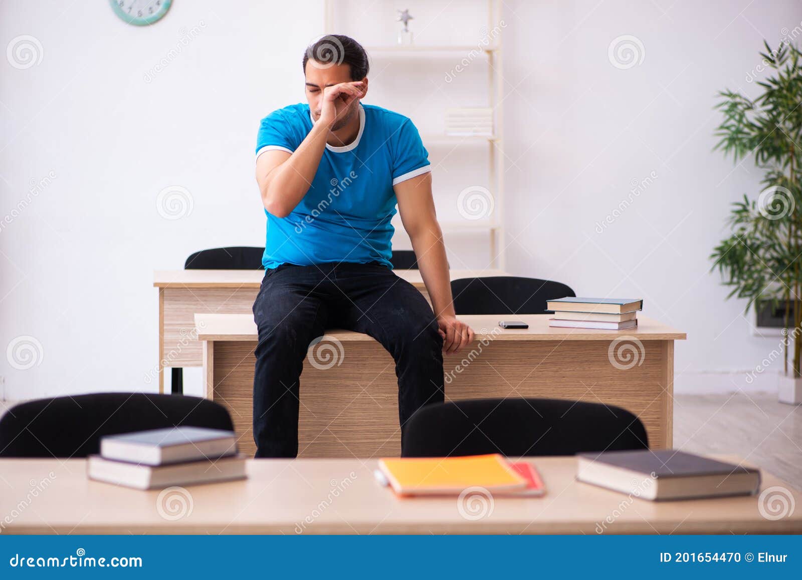 Exhausted Male Student Preparing for the Exams in the Classroom Stock ...