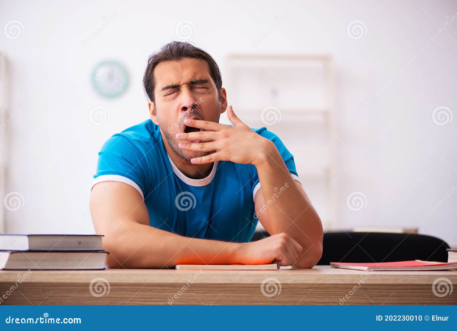 Exhausted Male Student Preparing for the Exams in the Classroom Stock ...