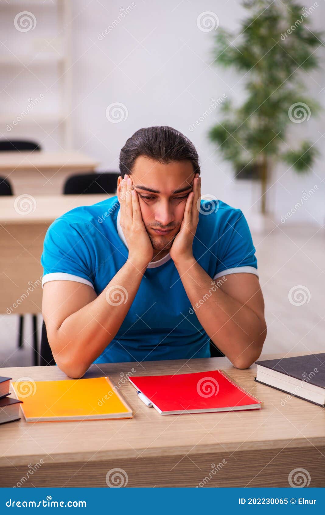 Exhausted Male Student Preparing for the Exams in the Classroom Stock ...