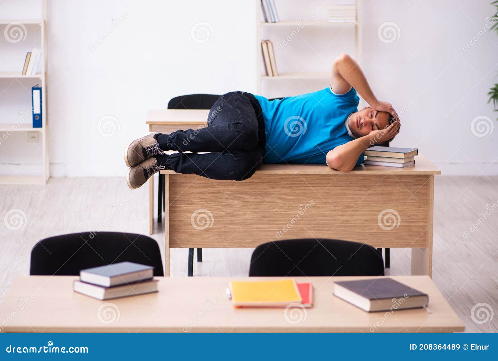 Exhausted Male Student Preparing for the Exams in the Classroom Stock ...