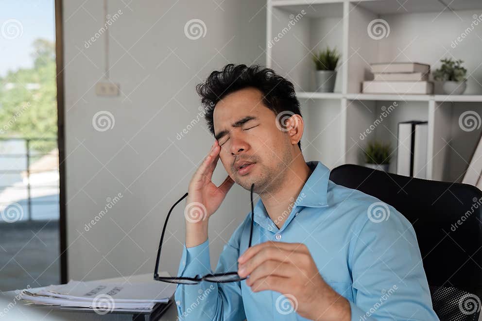 Exhausted Office Worker Experiencing Headache from Intense Workload in ...