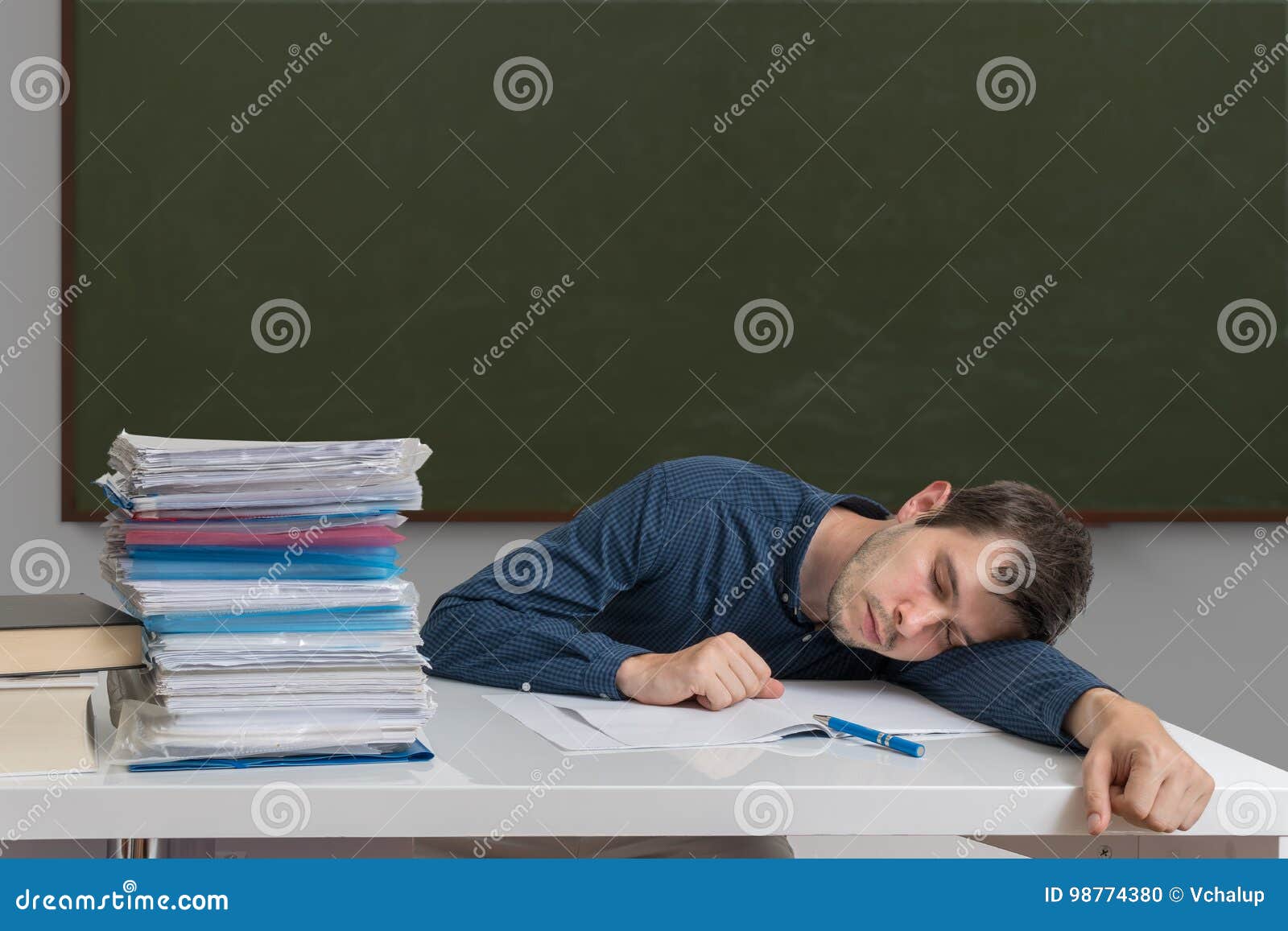 Exhausted and Overworked Teacher is Sleeping on Desk in Classroom Stock ...