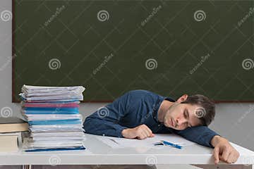 Exhausted and Overworked Teacher is Sleeping on Desk in Classroom Stock ...