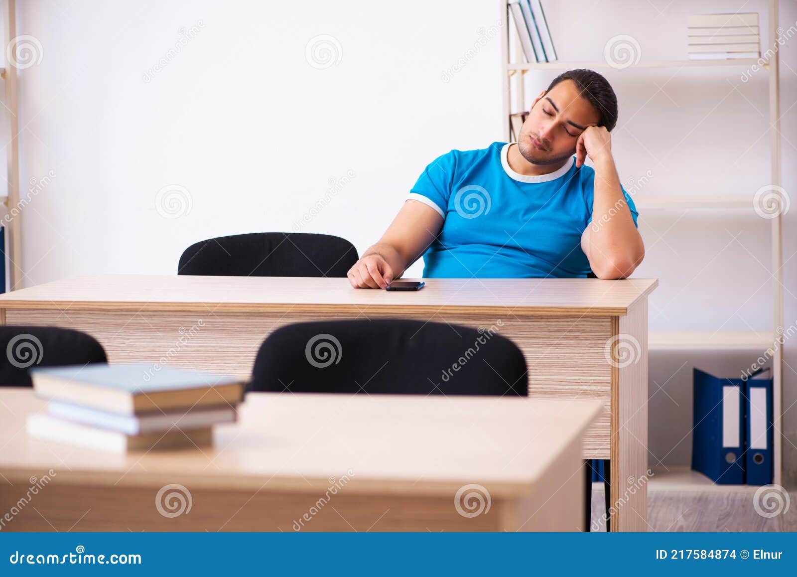 Exhausted Male Student Preparing for the Exams in the Classroom Stock ...