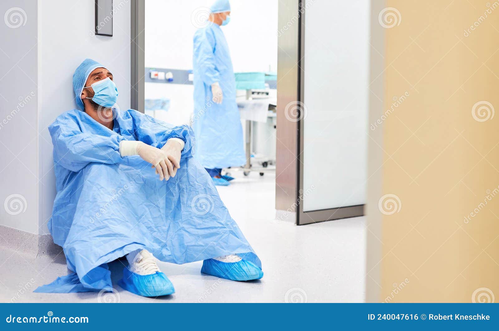 Exhausted Surgeon Sits on Floor in Front of the Operating Room Stock ...