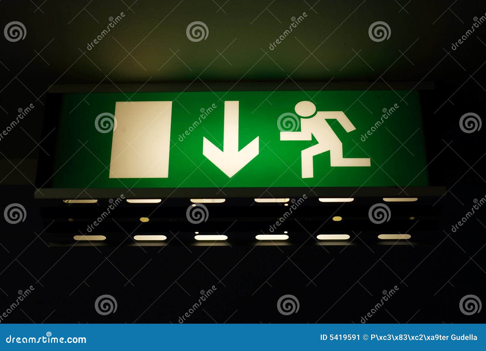 Glowing Emergency Exit Sign With Left Arrow At A Building. Safety First ...