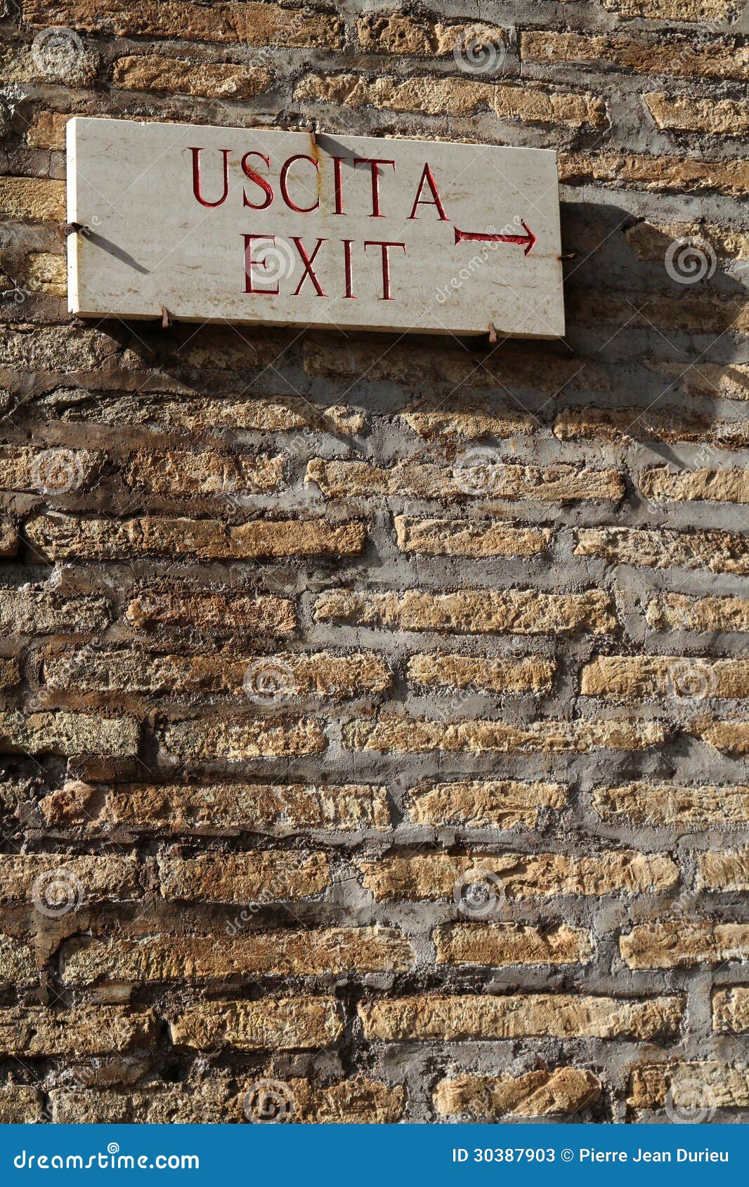 Exit sign on a brick wall stock image. Image of direction - 30387903