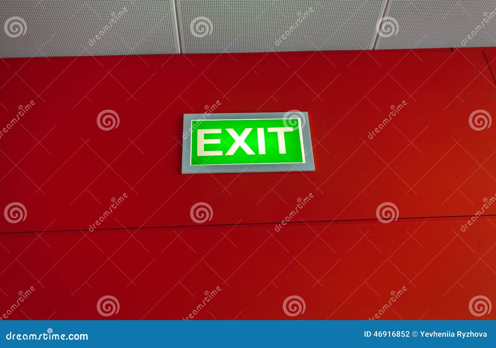 Exit Sign Glowing on Red Wall Stock Photo - Image of metal, bulb: 46916852