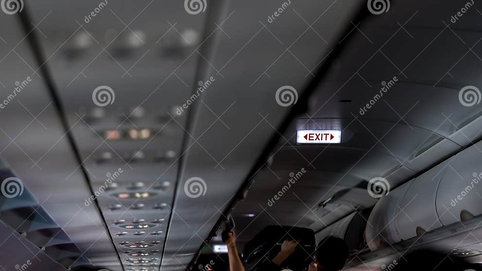 Exit Sign in Passenger Airplane. Emergency Exit Sign on Airplane Stock ...