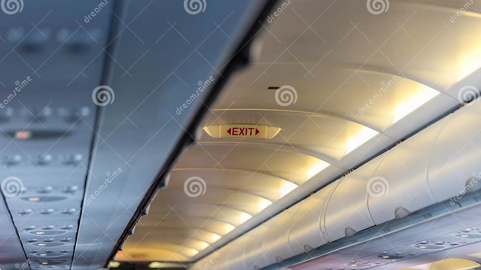 Exit Sign in Passenger Airplane. Emergency Exit Sign on Airplane Stock ...