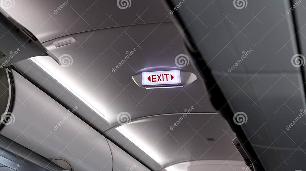 Exit Sign in Passenger Airplane. Emergency Exit Sign on Airplane Stock ...