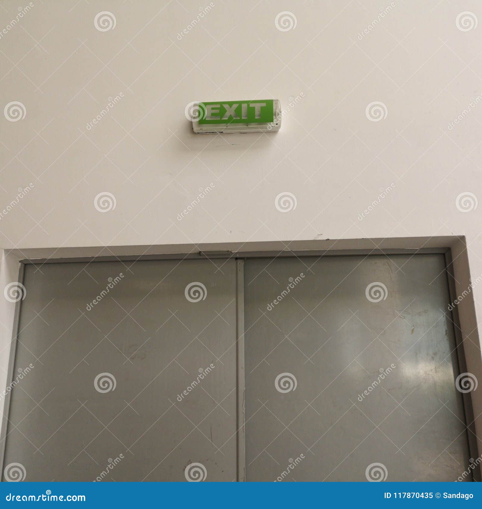 Exit Sign on the Wall stock image. Image of electrical - 117870435