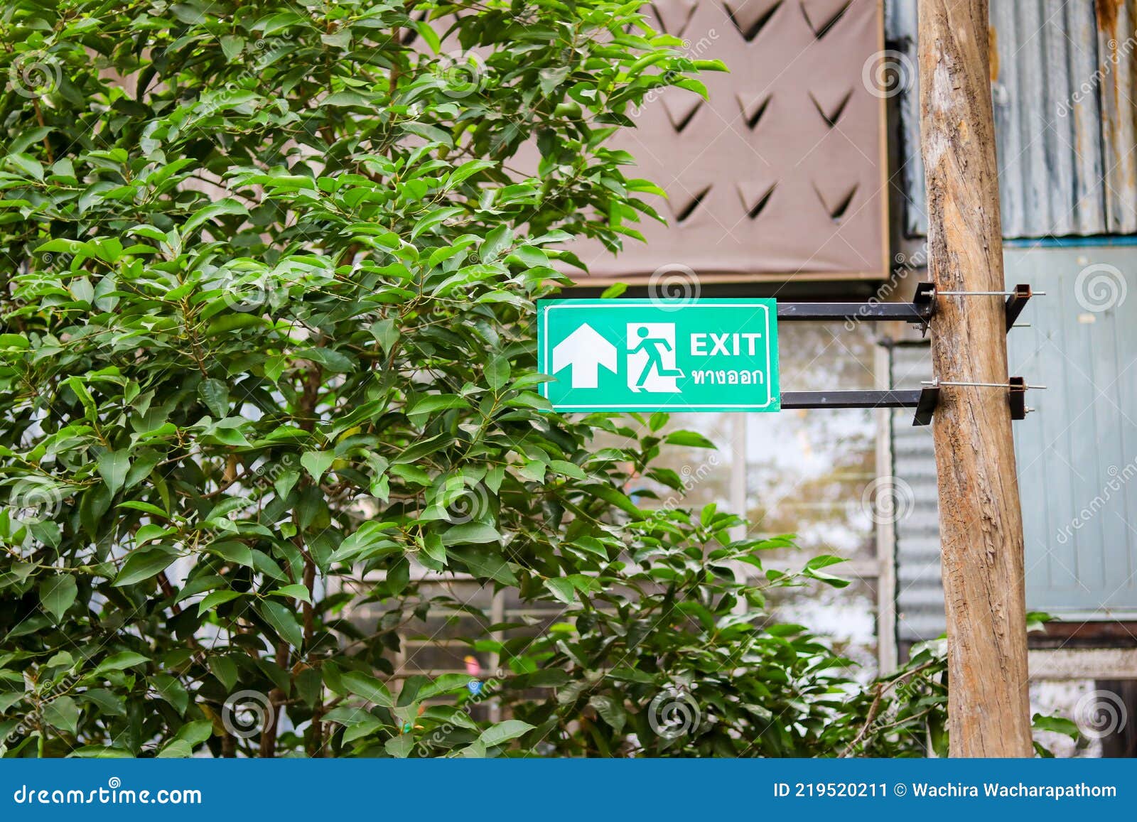 Exit sign on a wooden pole stock image. Image of street - 219520211