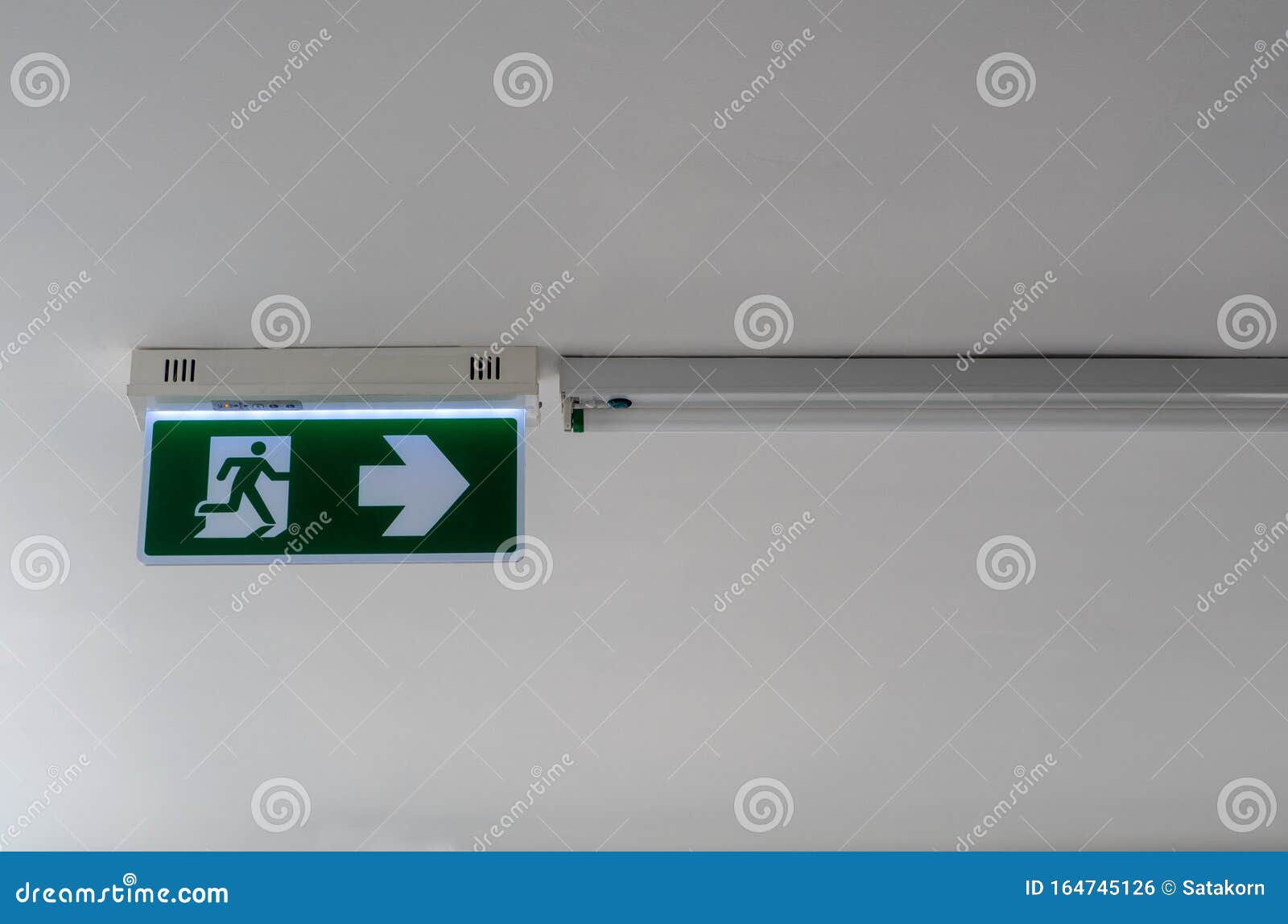 Exit Signs, Fire Exits and Arrows Pointing the Way on the Ceiling of ...