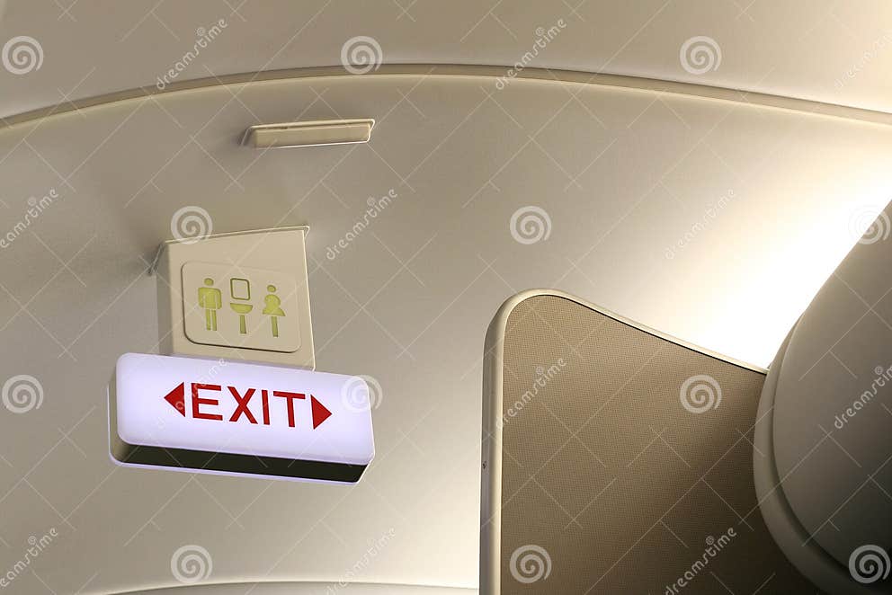 Exit and Toilet Sign on Board Airplane Stock Photo - Image of lighted ...