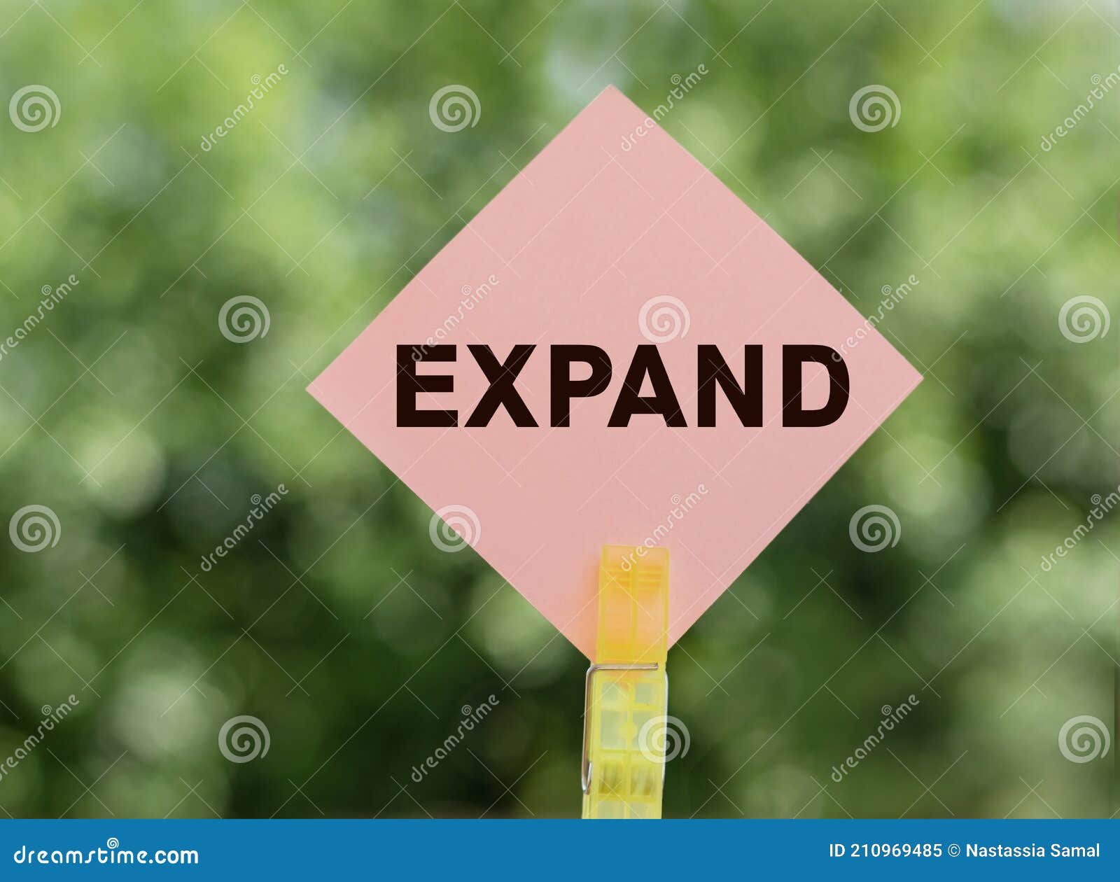 EXPAND - Text on Pink Note Paper on Green Background Stock Image ...