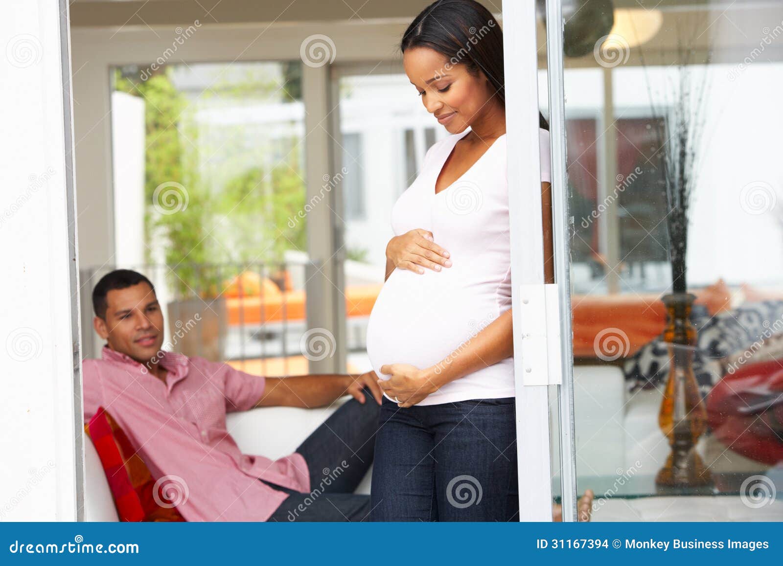 Expectant Couple Relaxing at Home Together Stock Photo - Image of ...