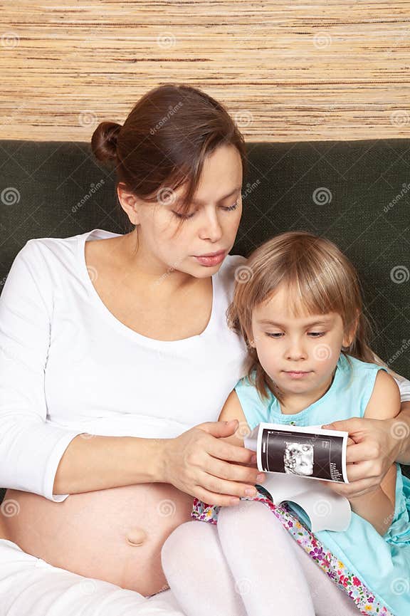 Expectant Mother And Daughter Looking At Ultrasound Stock Image Image
