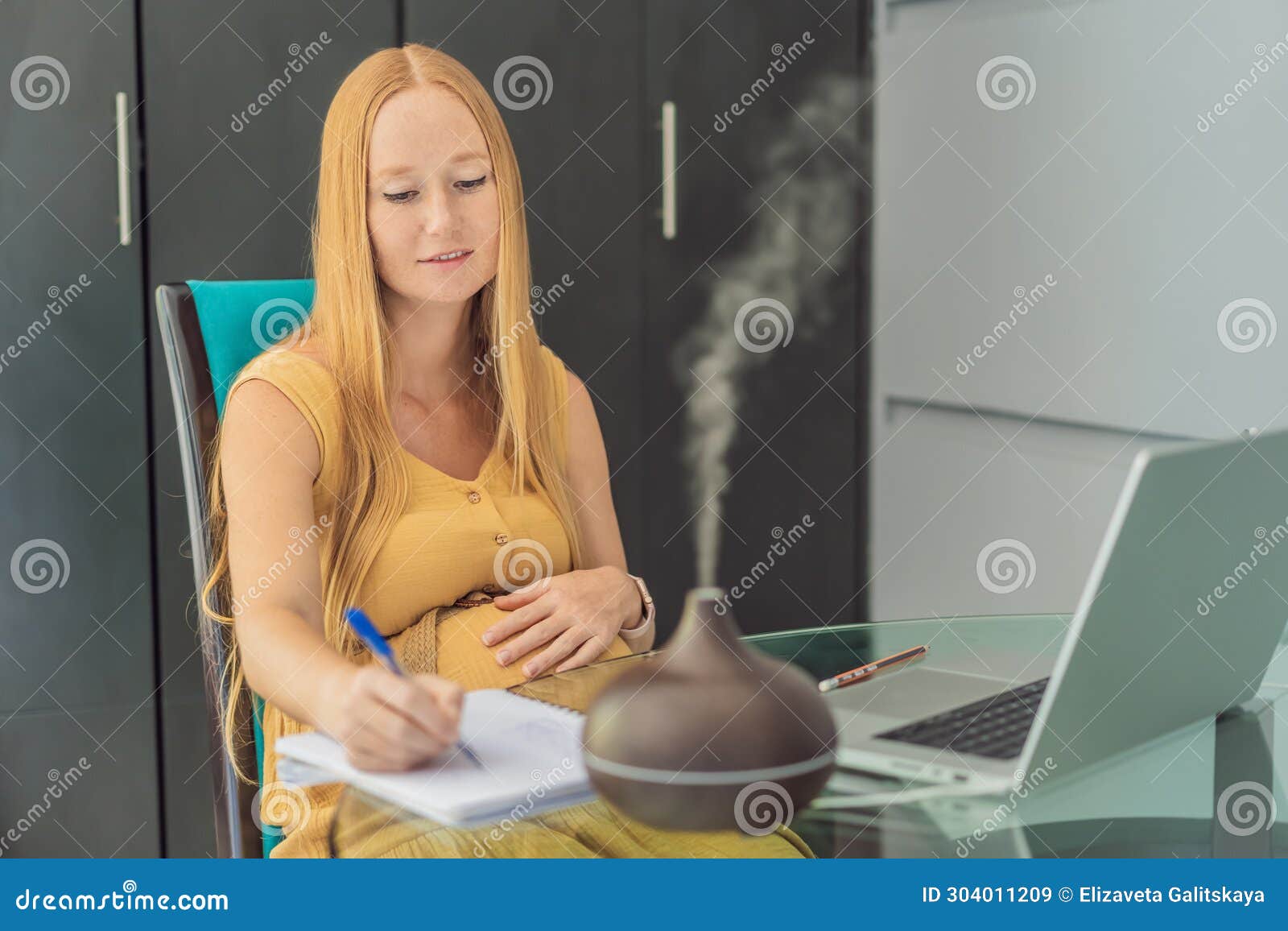 Expectant Woman Enhances Work Environment, Using an Aroma Diffuser for ...