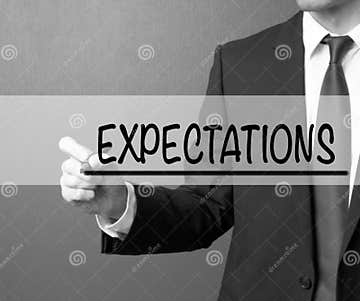 Expectations. Businessman in a Suit with a Marker Writing on Visual ...