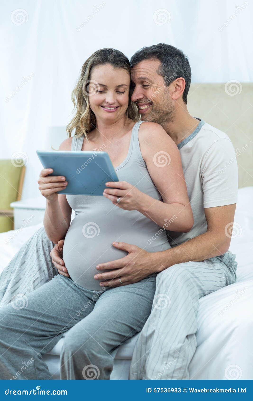 Expecting Couple Sitting on Bed Stock Image - Image of gestation ...