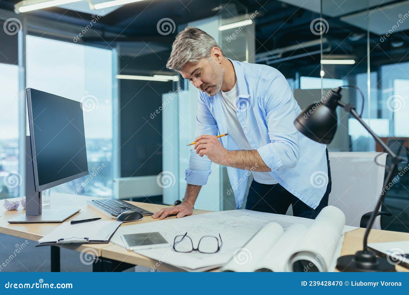 Architect, Working at the Office Desk on the Drawing, Makes Final Edits ...