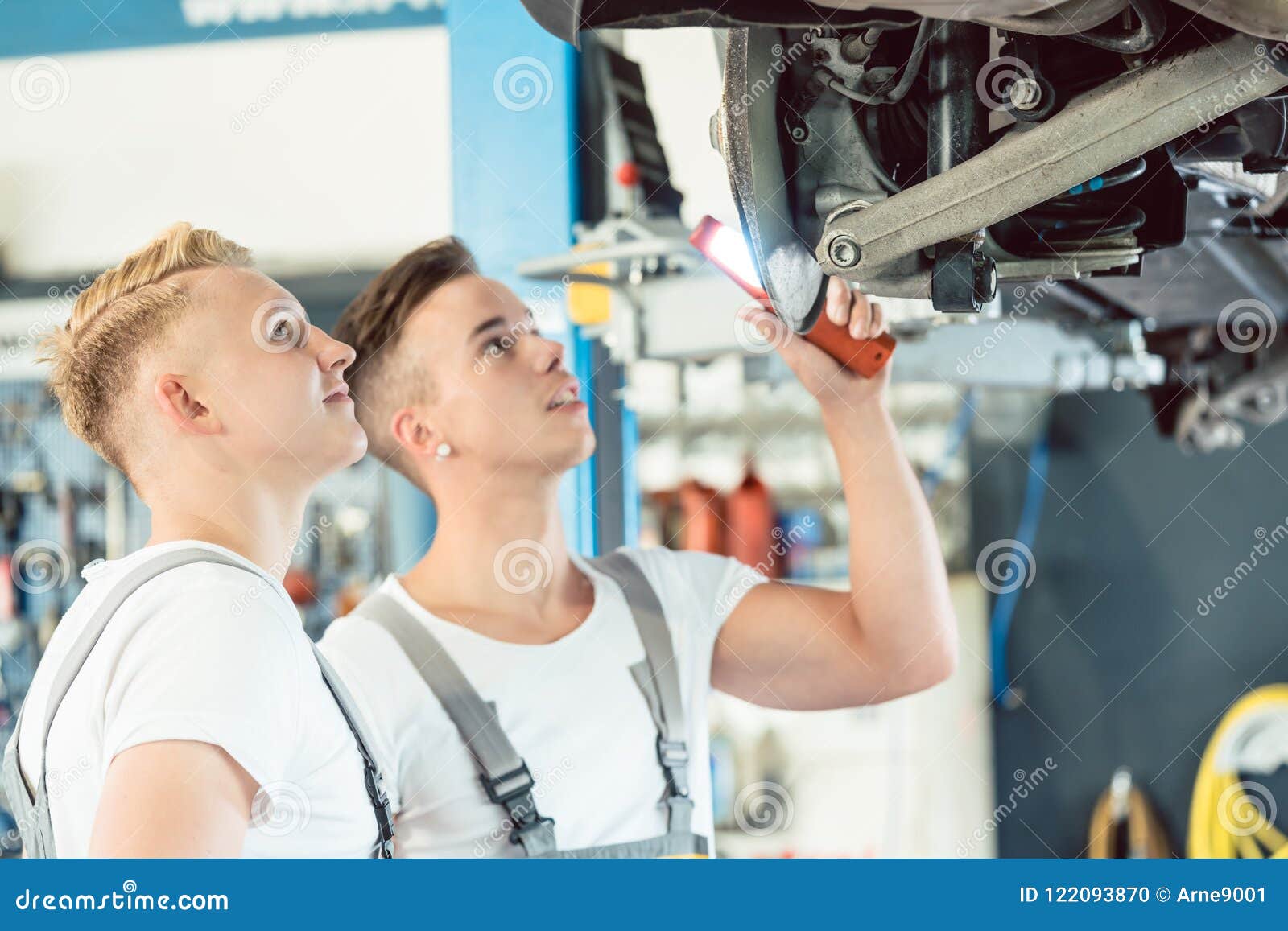 Experienced Auto Mechanic Teaching an Apprentice about Disk Brakes ...
