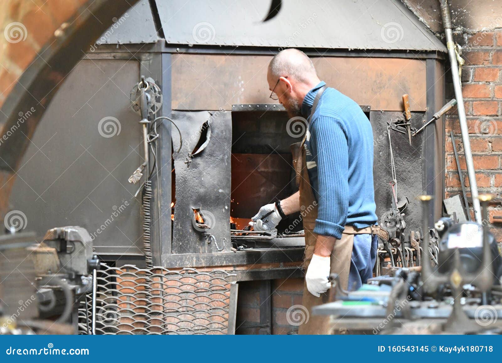An Experienced Blacksmith Works with Open Fire. a Blacksmith ...