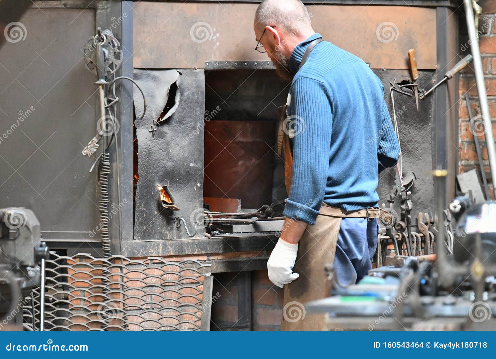 An Experienced Blacksmith Works with Open Fire. a Blacksmith ...