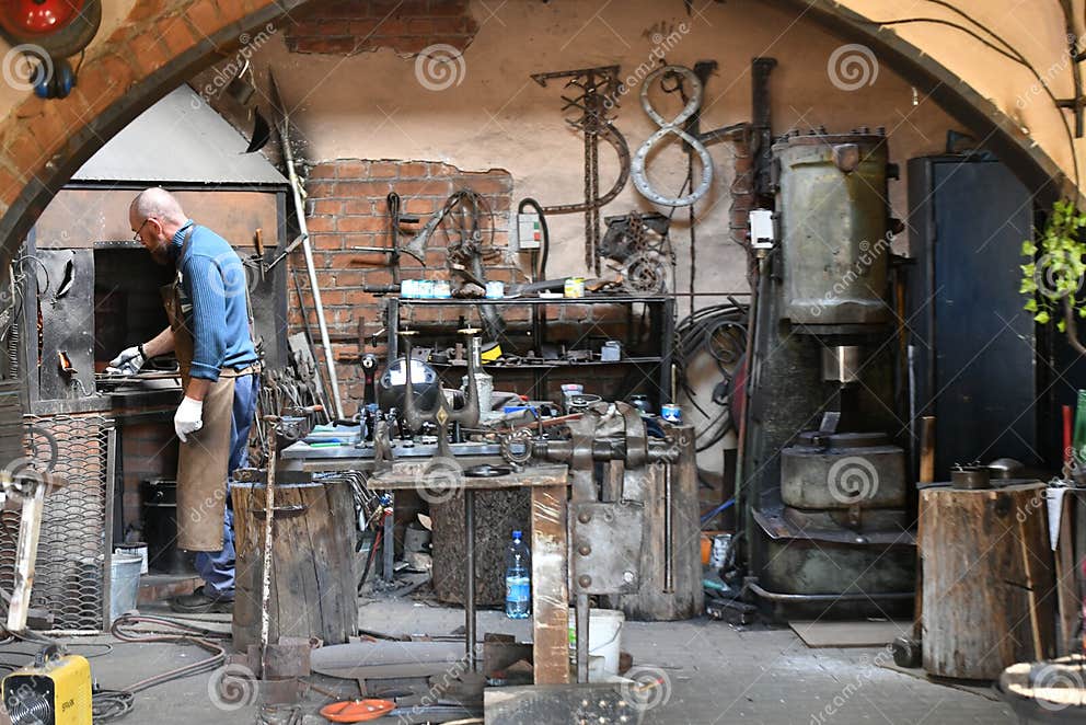 An Experienced Blacksmith Works with Open Fire. a Blacksmith ...