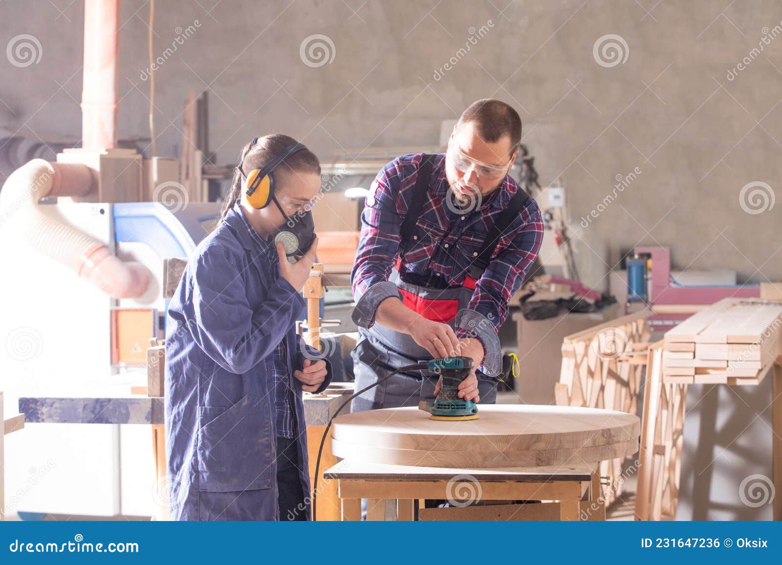 Experienced Carpenter Teaching Young Apprentice at Workshop Stock Photo ...