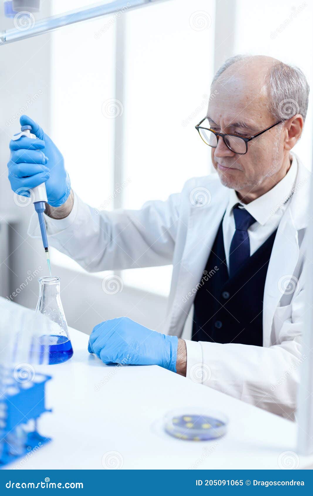 Experienced Chemist Engineering Blue Solution in Modern Laboratory ...