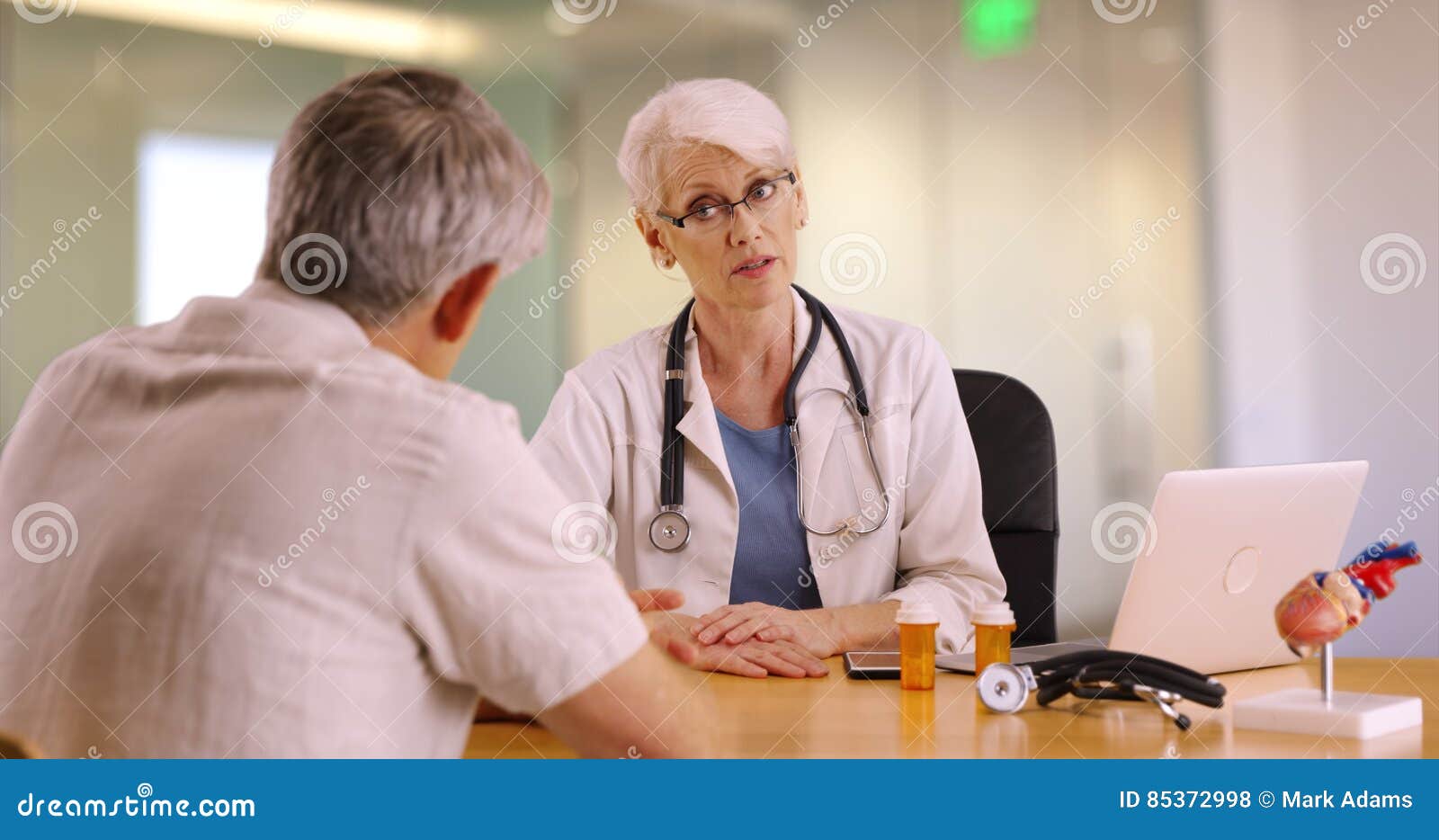 Experienced Doctor Talking with Elderly Man in the Office Stock Photo ...