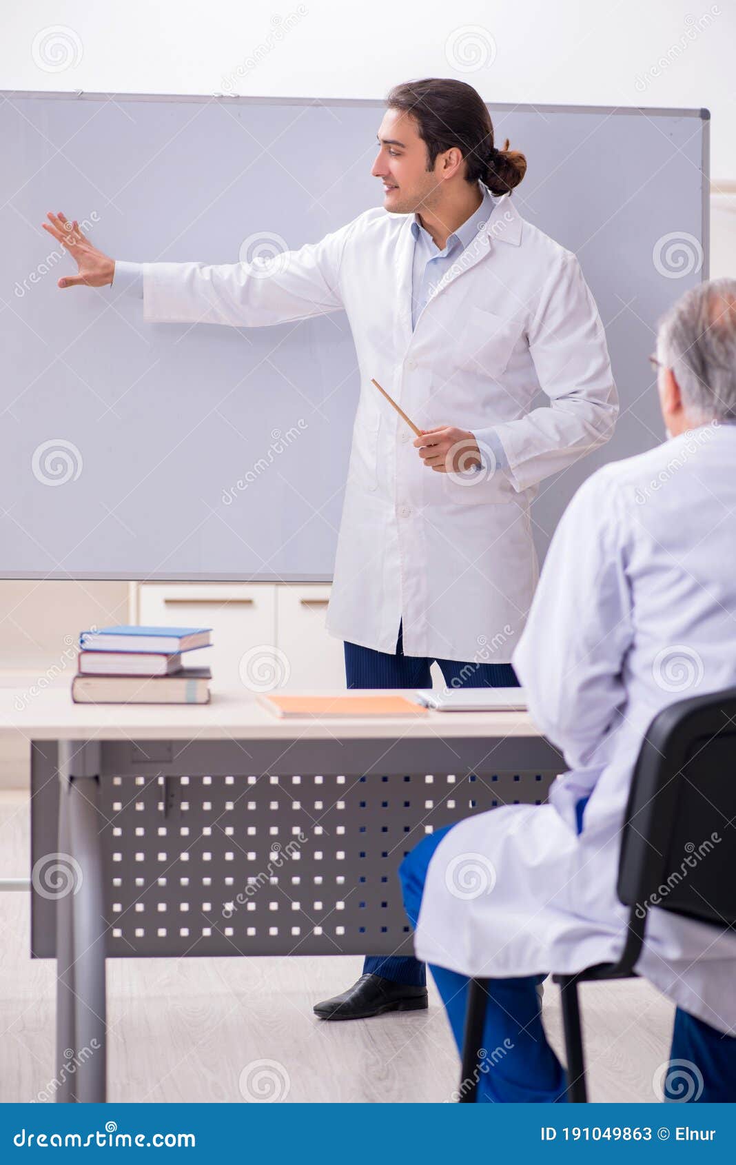 Experienced Doctor Teaching Young Male Assistant Stock Image - Image of ...
