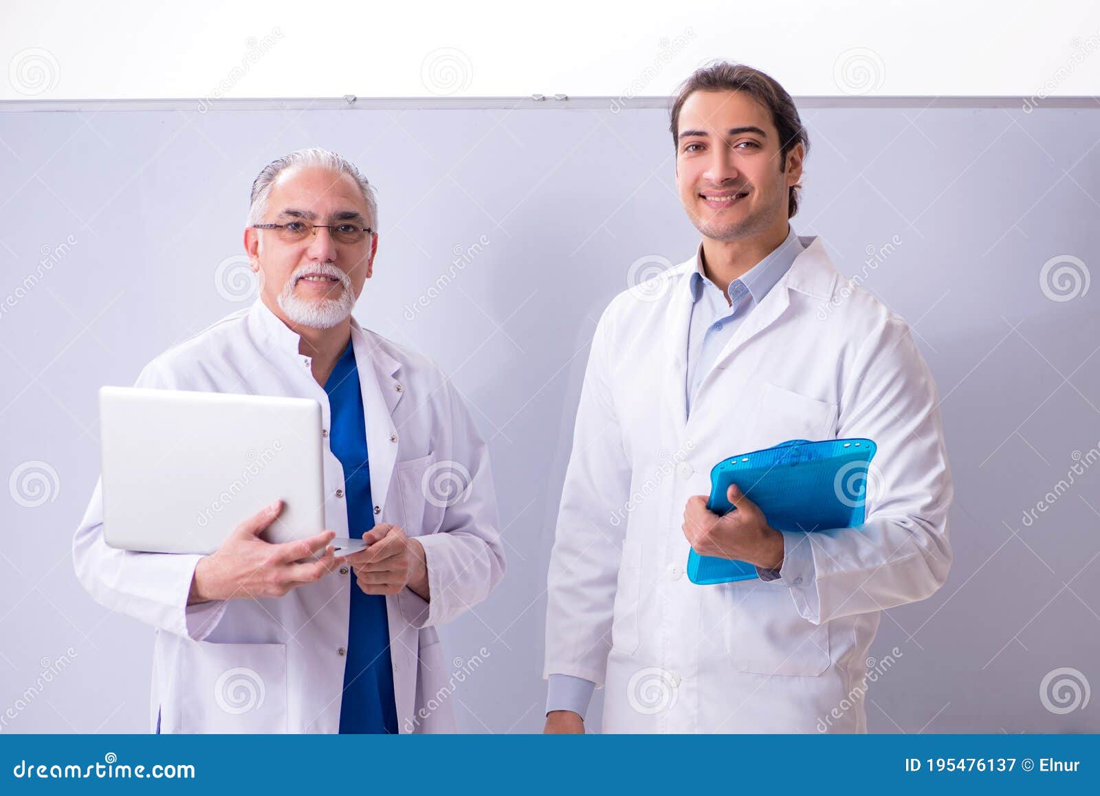 Experienced Doctor Teaching Young Male Assistant Using Computer Stock ...