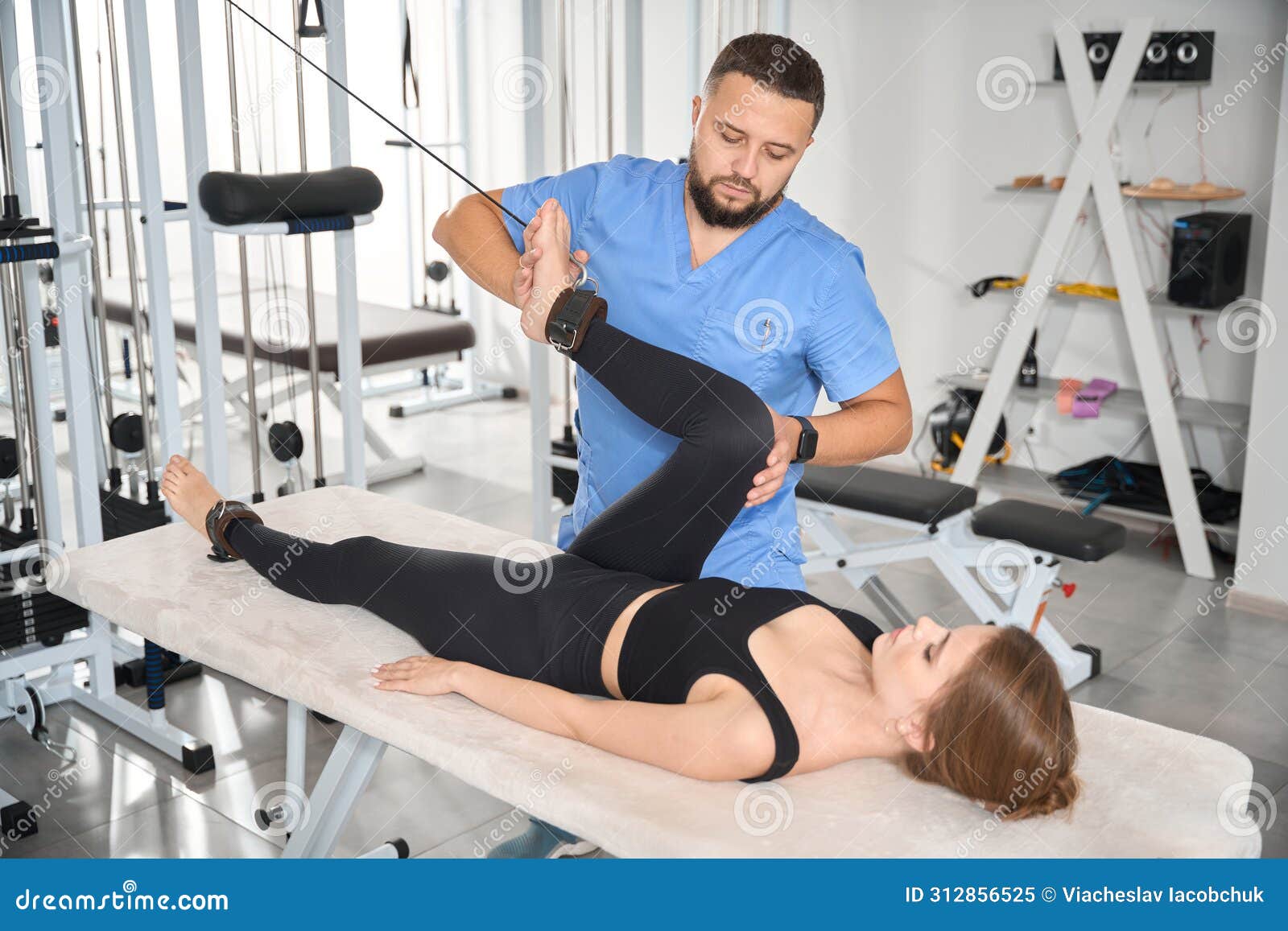 Experienced Kinesiologist Uses a Special Simulator To Work with Patient ...