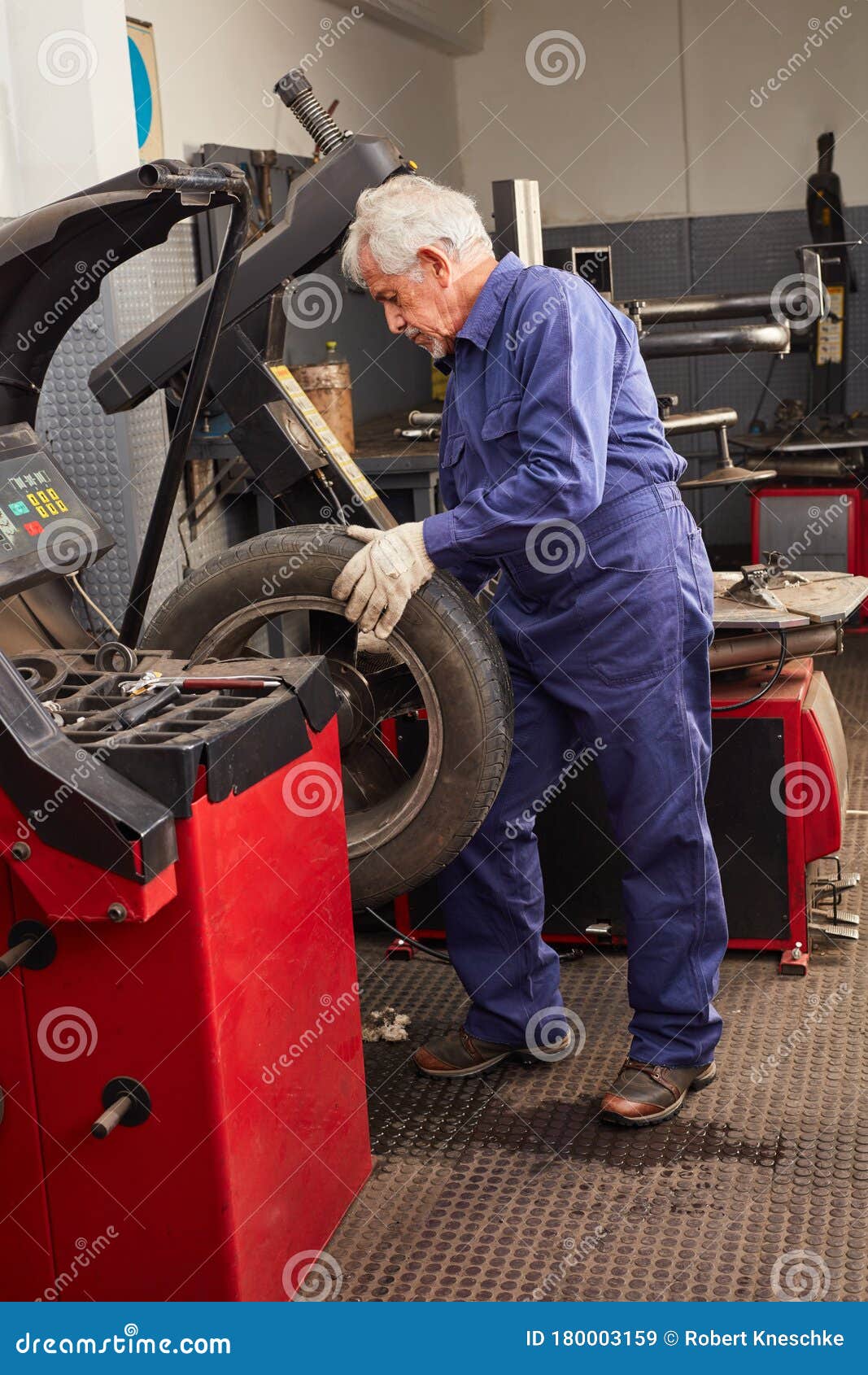 Experienced Mechanic in the Car Workshop with Tires Stock Image - Image ...