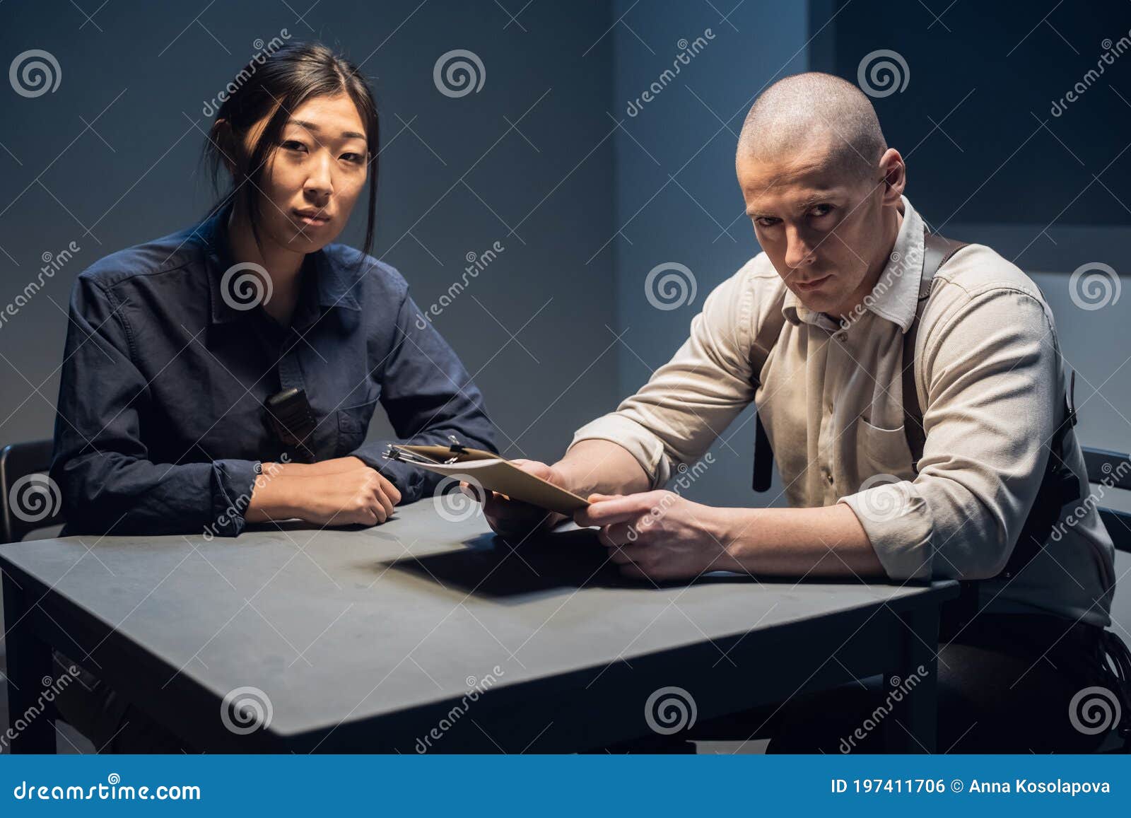 An Experienced Police Officer and His Young Assistant Sit at the Table ...