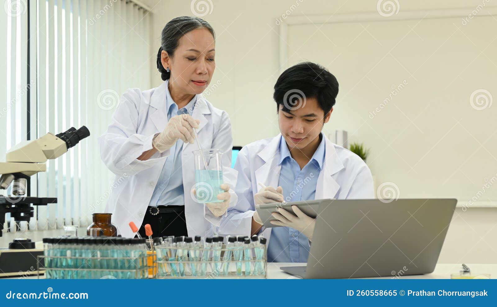 Experienced Scientists Team Conducting Experiments in Laboratory ...
