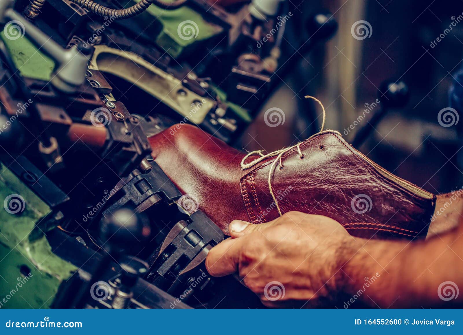 Experienced Shoemaker Using a Special Machine for Putting Shoes on the ...