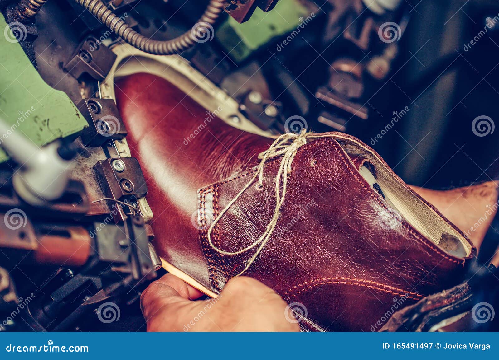 Experienced Shoemaker Using a Special Machine for Putting Shoes on the ...
