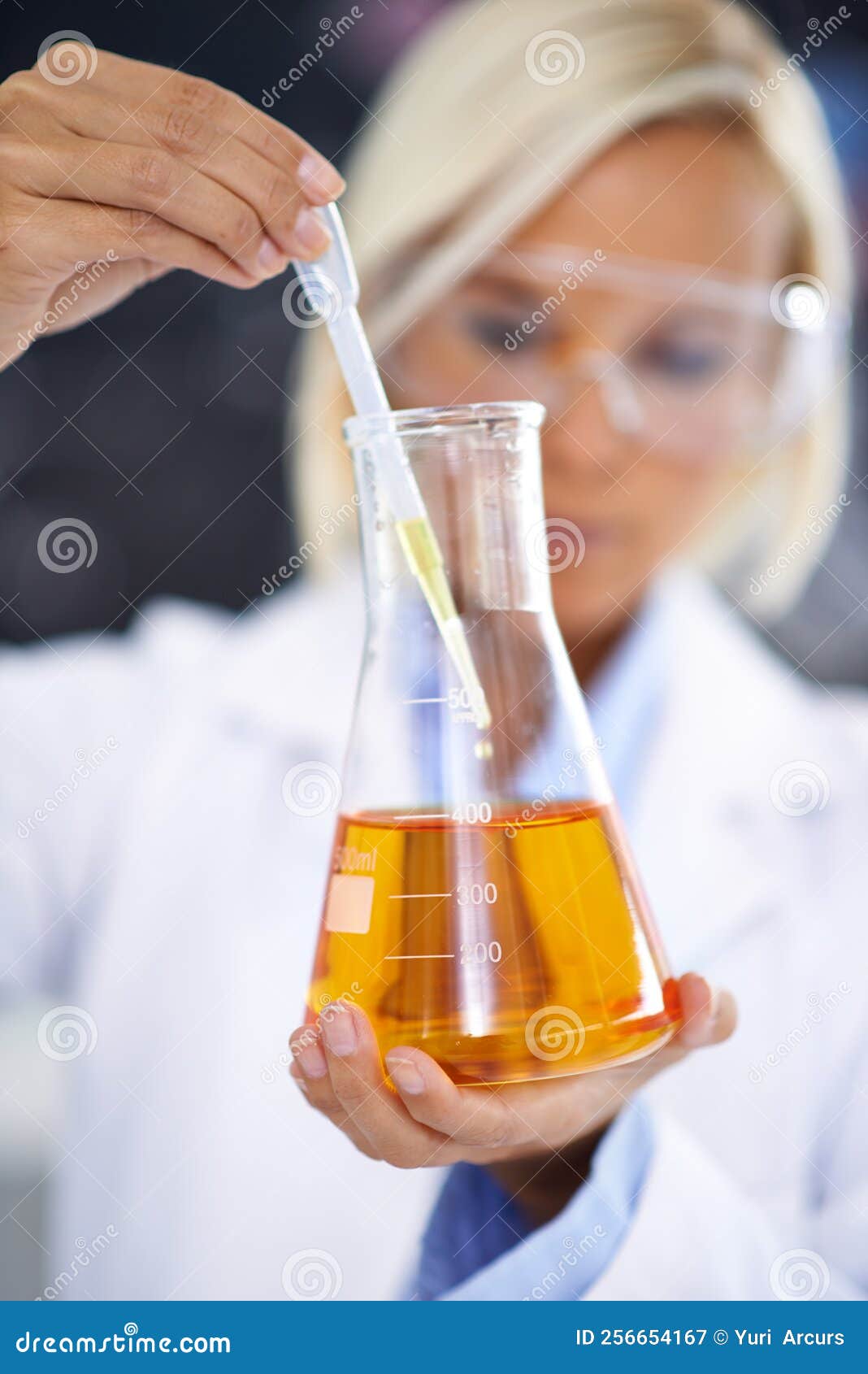 Experimentation is the Heart of Discovery. a Lab Technician Holding Up ...