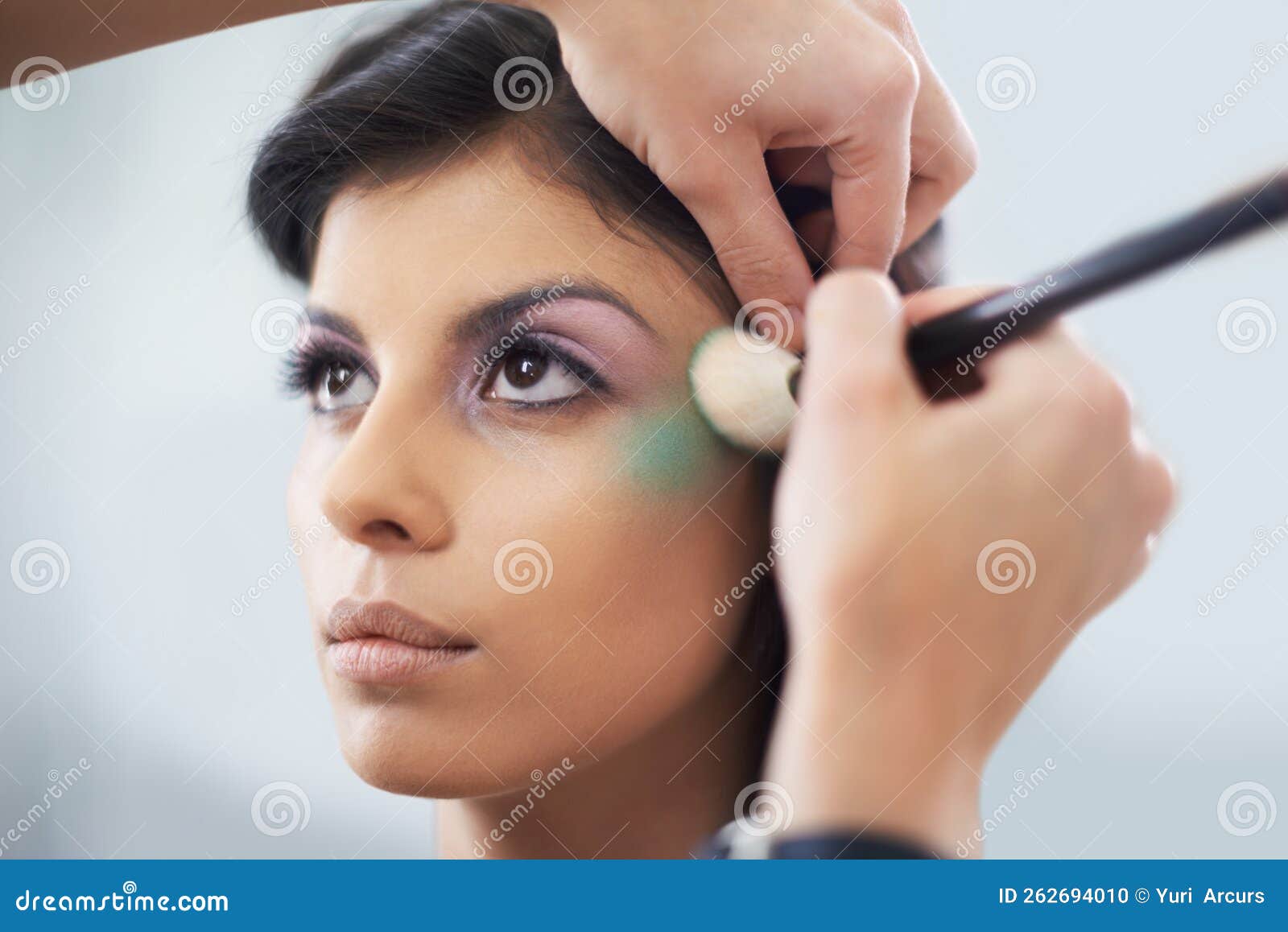 Experimenting with Bold Colours. a Young Woman Having Makeup Applied ...